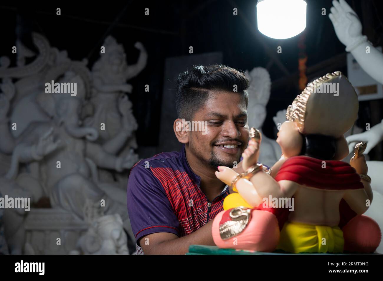 Mumbai, India August 29 2023 An artist working on Ganesha idol colorful ...