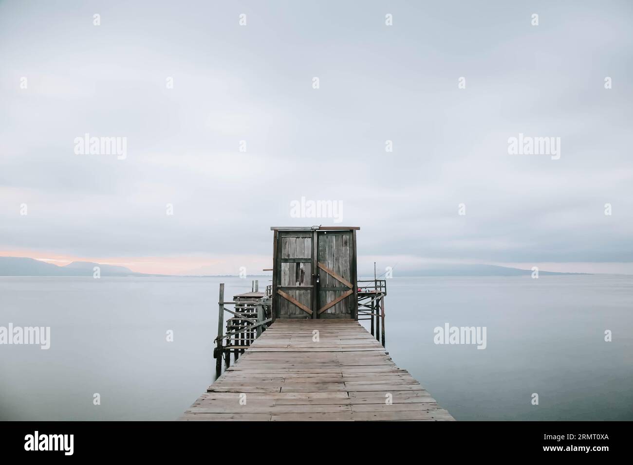Old and traditional dock port made of wood during cloudy day. Fisheries ...