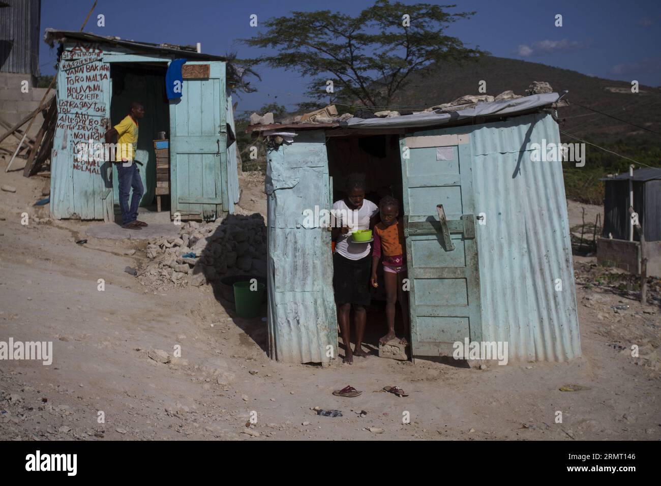 (140809) -- JIMANI, -- Residents are seen at their home doors at La Q ...