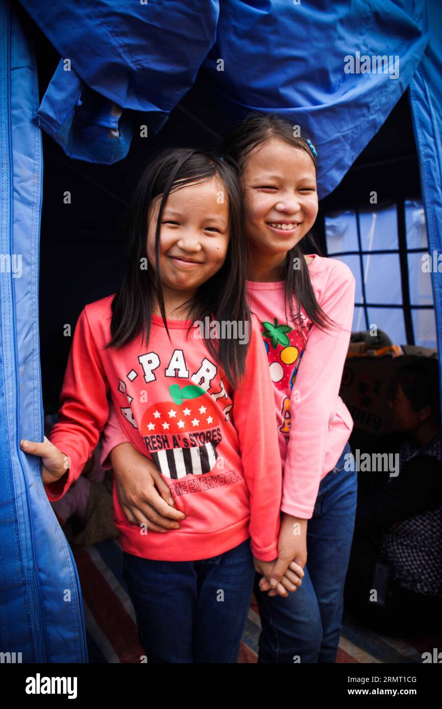 Tang Tianhuan (R) and her younger sister Tang Tianxing pose for photos ...