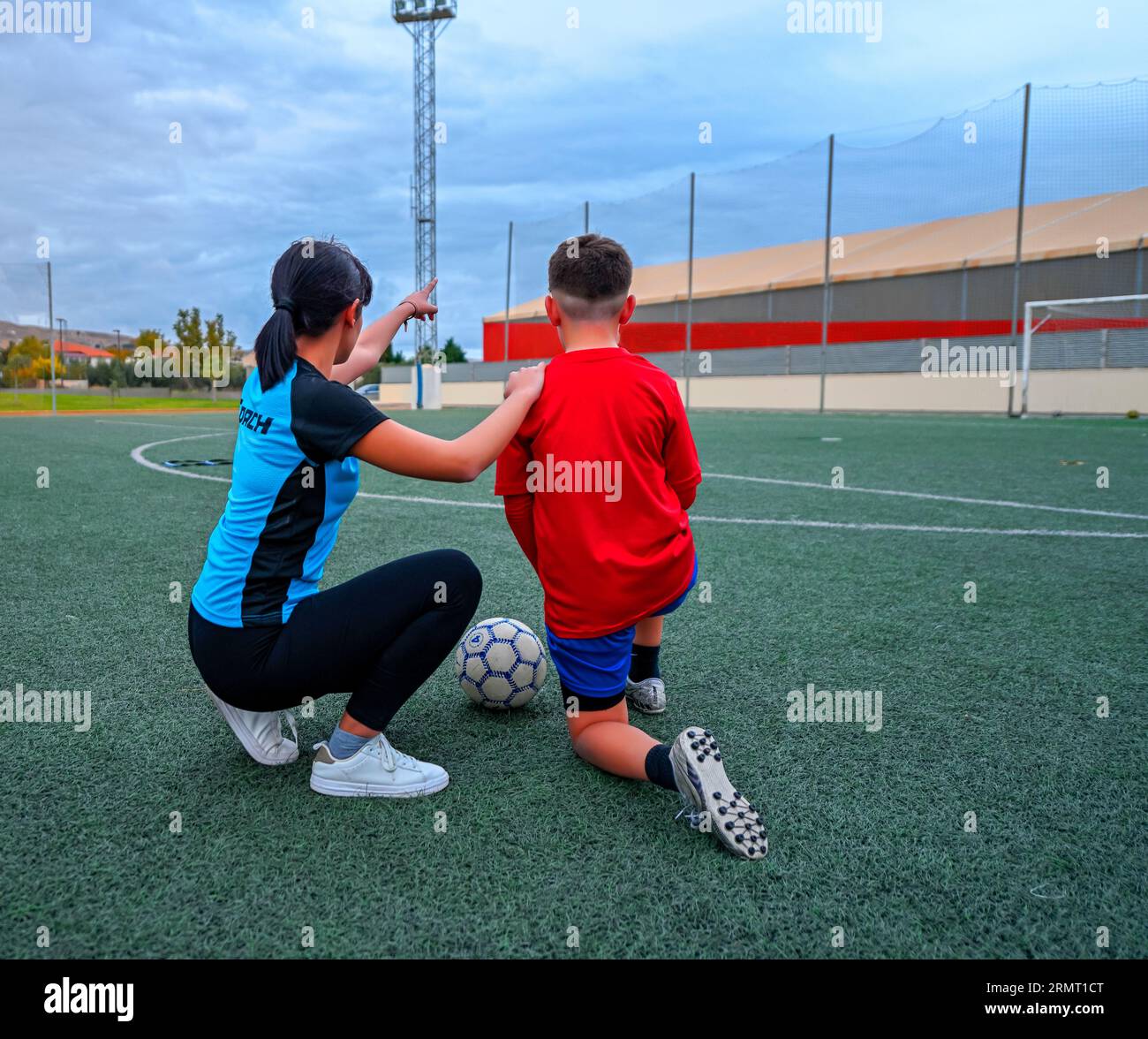 Youth soccer coach, directs daily training Stock Photo - Alamy