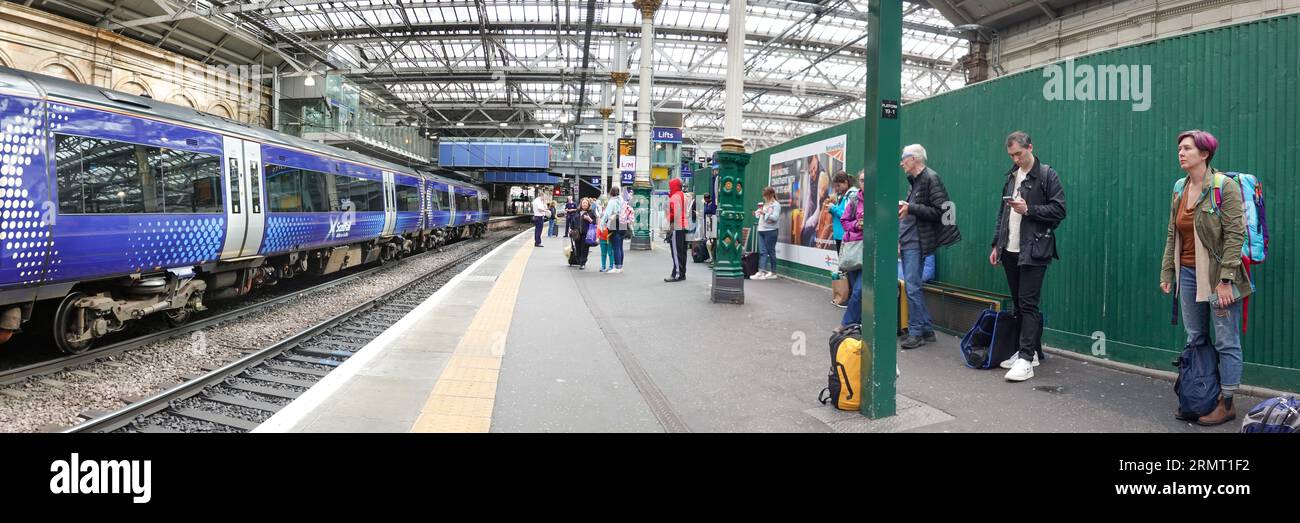 Passengers waiting for train on Platform 19, Scotrail train on ...