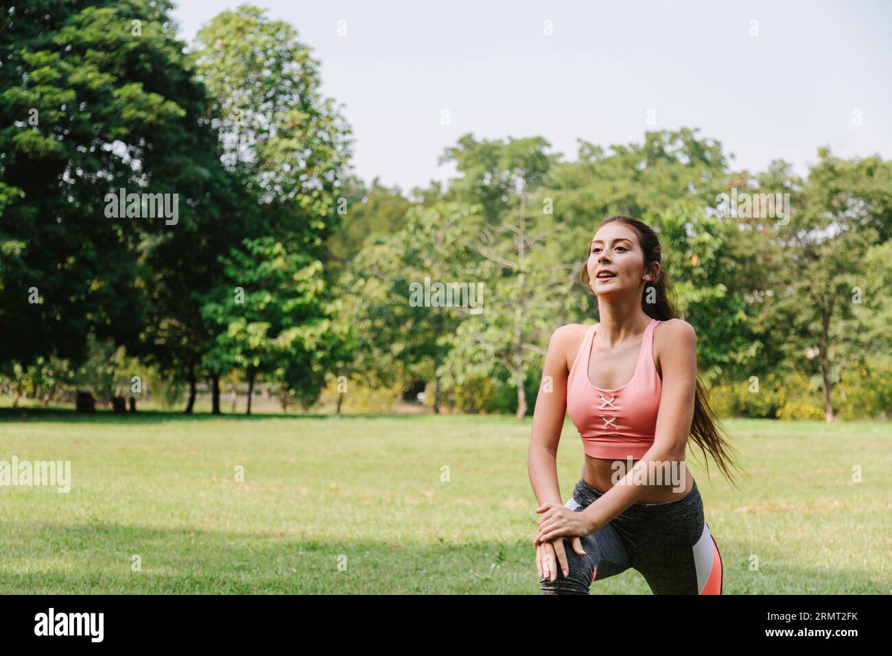 sports woman working out and stretching warm up leg muscle before ...