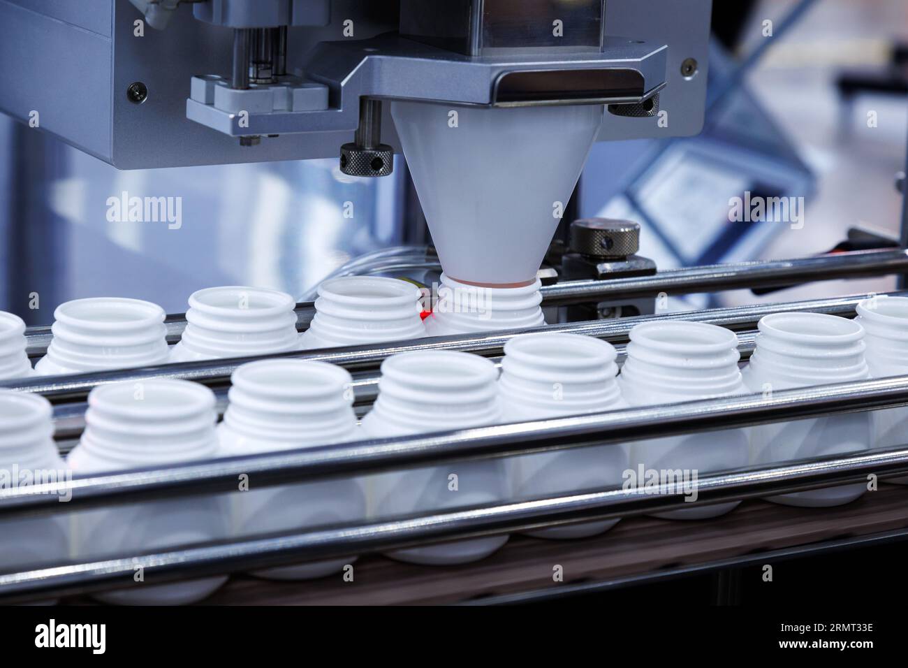 medicine pill capsules are filling in the white plastic bottle on ...