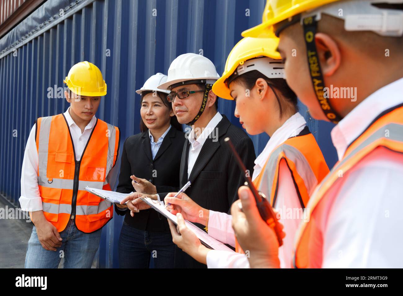 Warehouse business manager and port worker working and checking ...