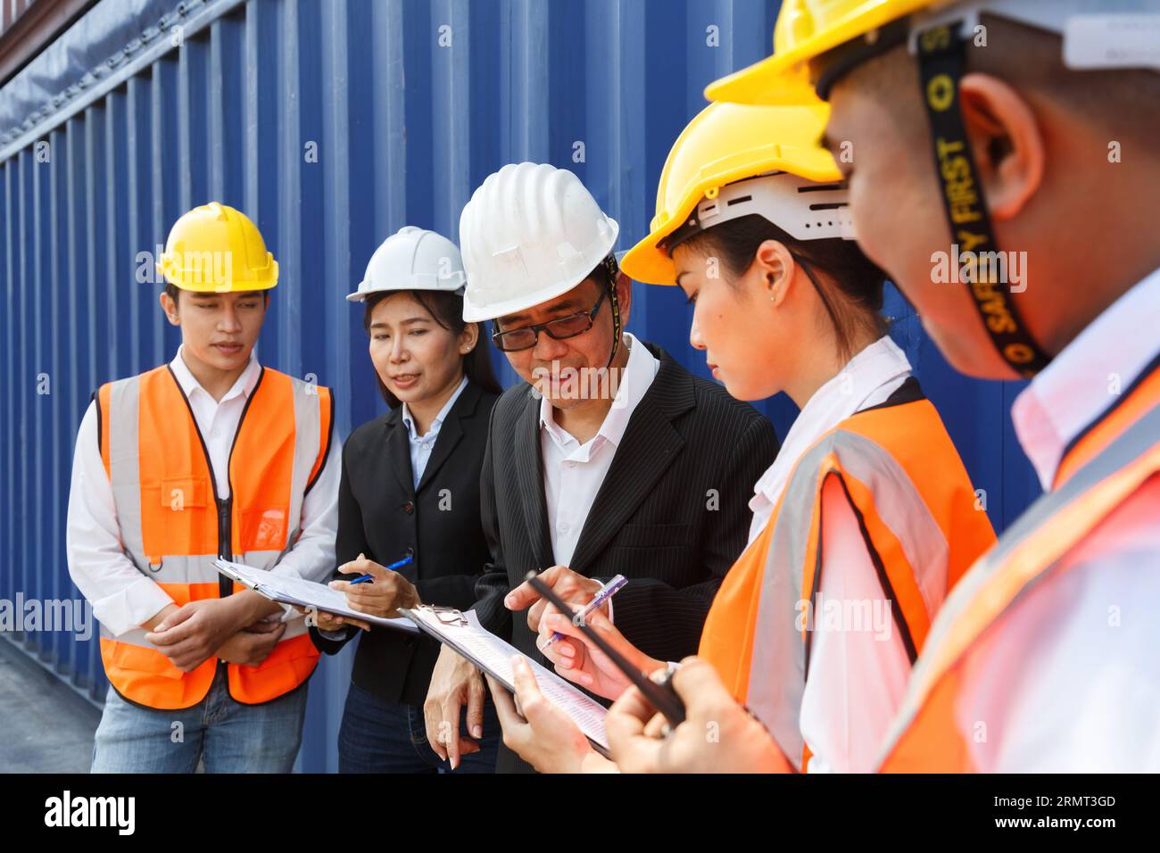 Warehouse business manager and port worker working and checking ...