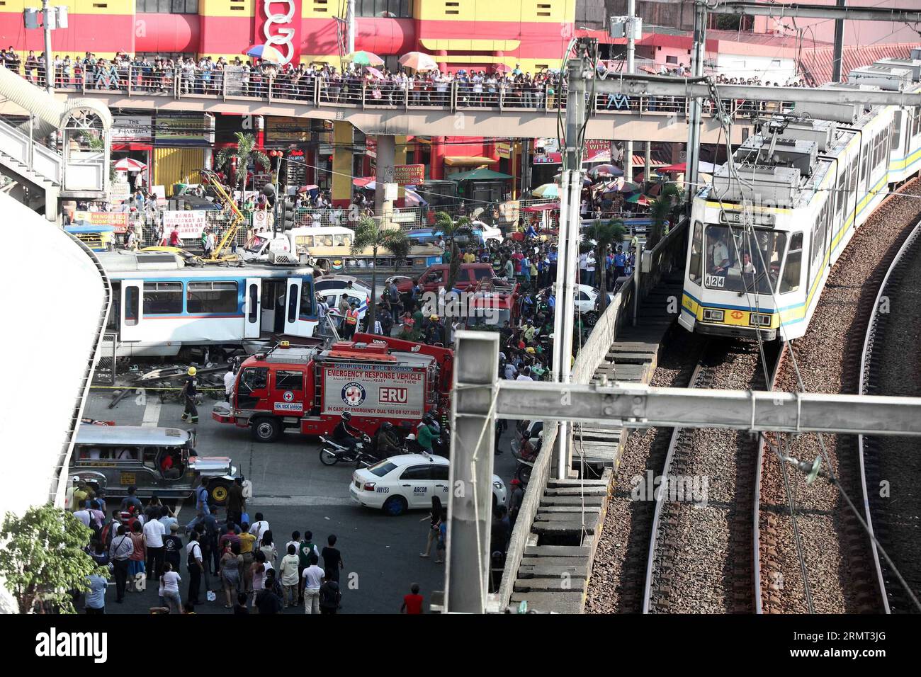 (140813) -- PASAY CITY, Aug. 13, 2014 -- People gather around a ...