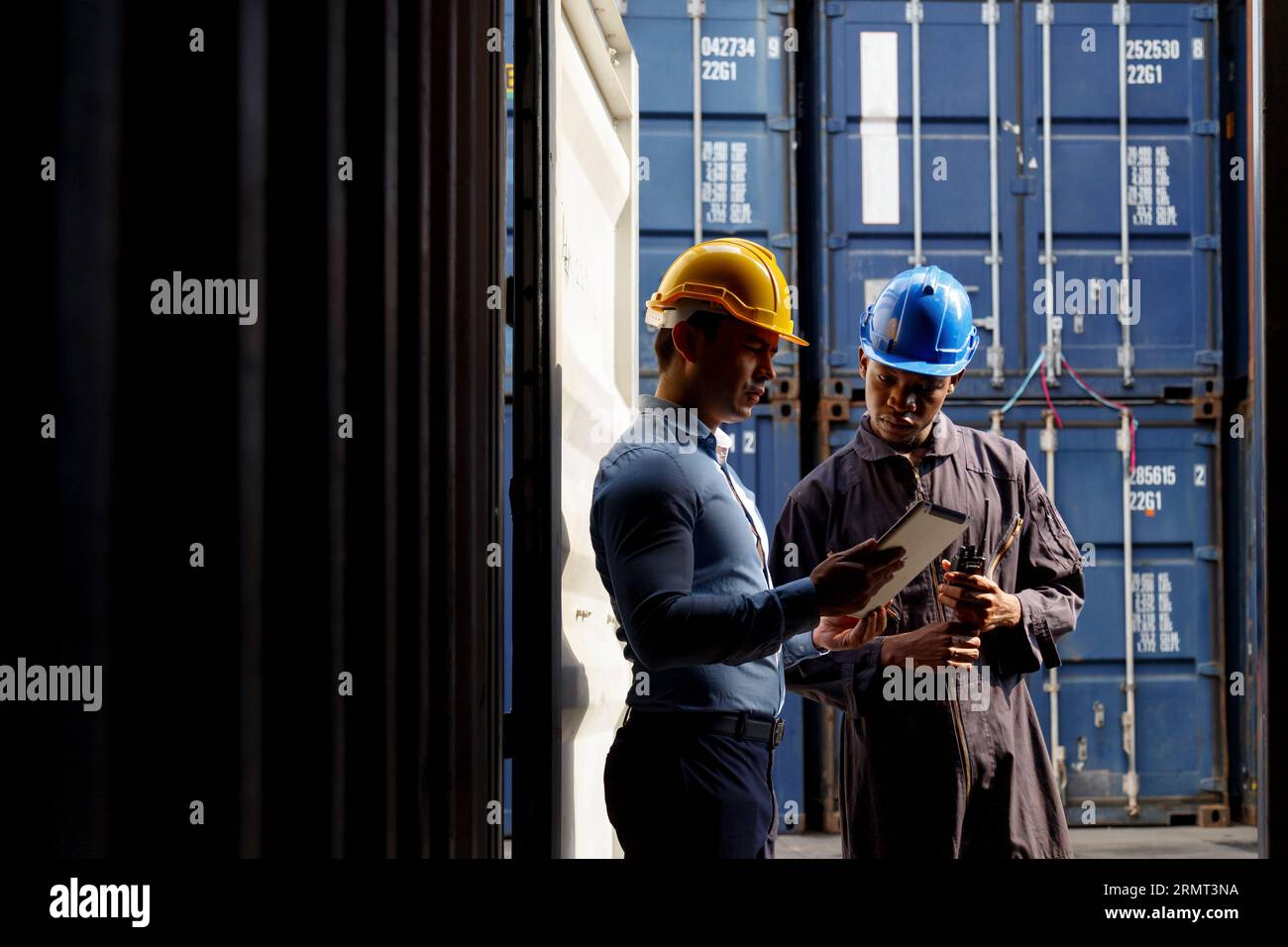 Warehouse business manager and port worker working and checking ...