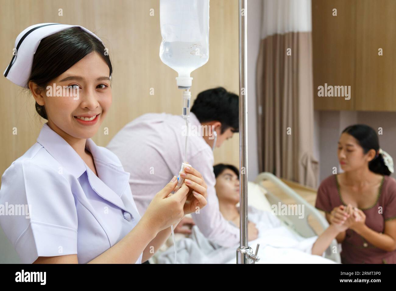 nurse giving medicine injection to iv tube for patient treatment at ...