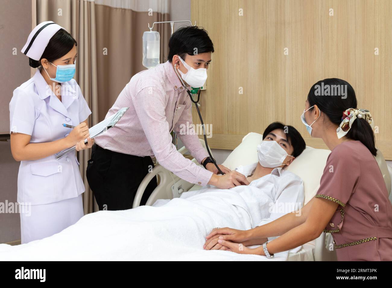 asian doctor using stethoscope listening heartbeat of patient and nurse ...