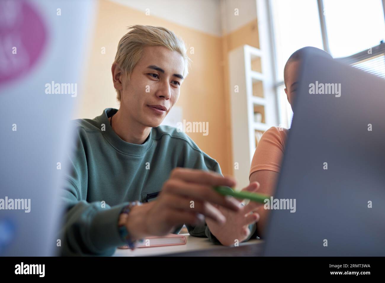 Focus on young Asian male student making presentation of new project or ...