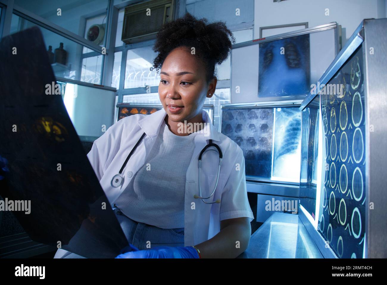 Female medical radiologist doctor looking head and brain x-ray film ...