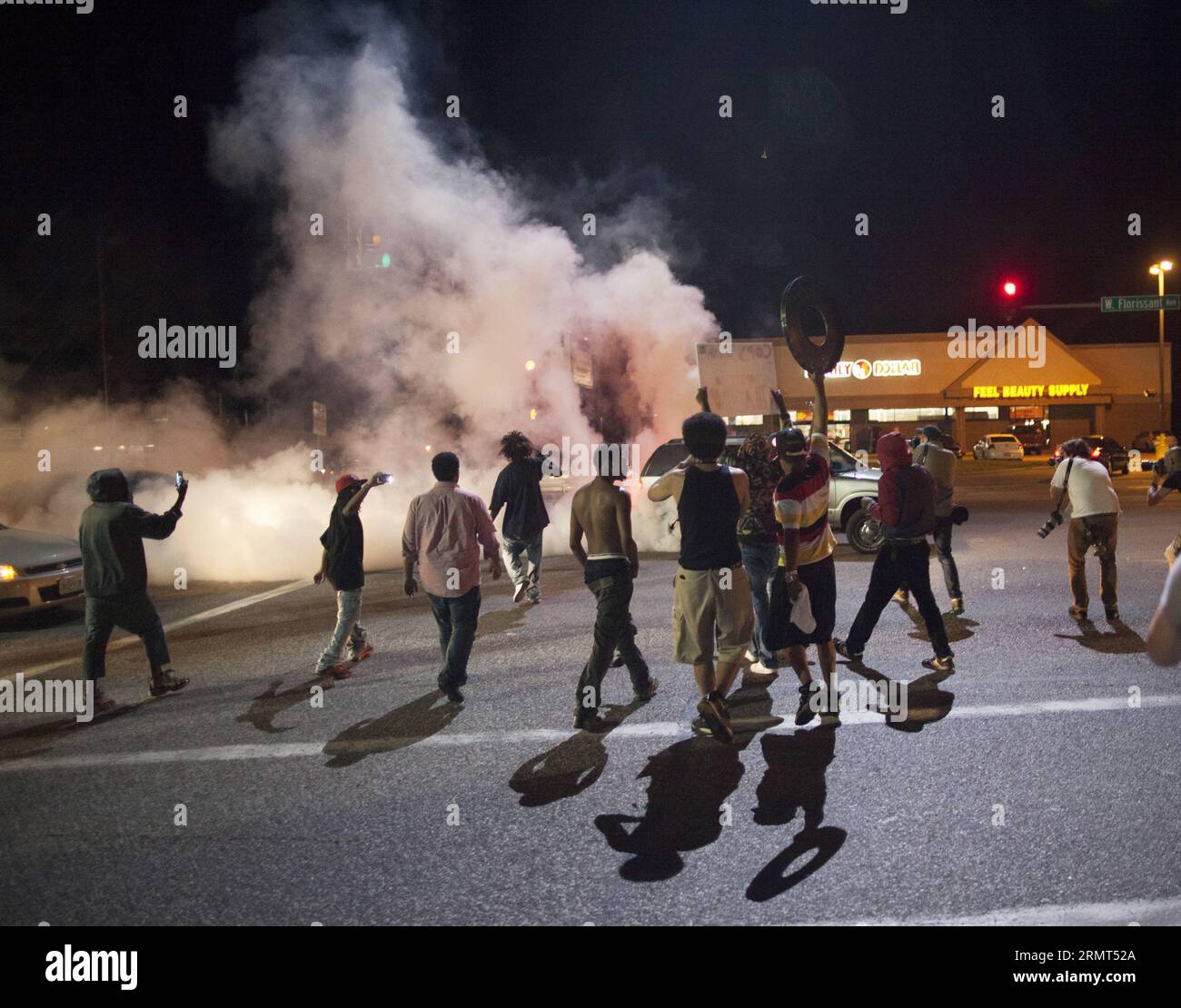 140815 -- FERGUSON, Aug. 15, 2014 -- Protesters shout slogans during a ...