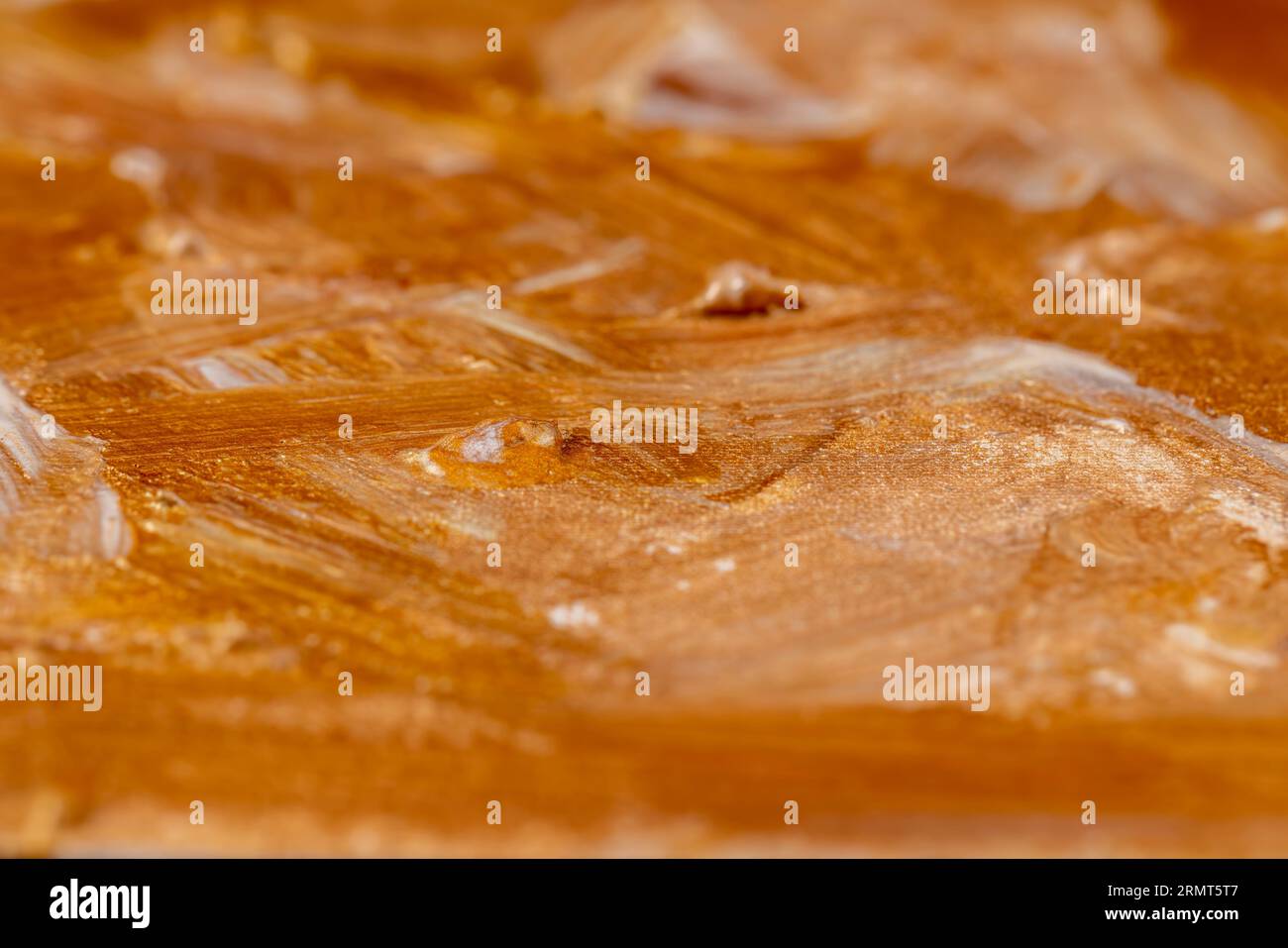 Abstract chaotic painting on canvas with gold paints, using gold ...