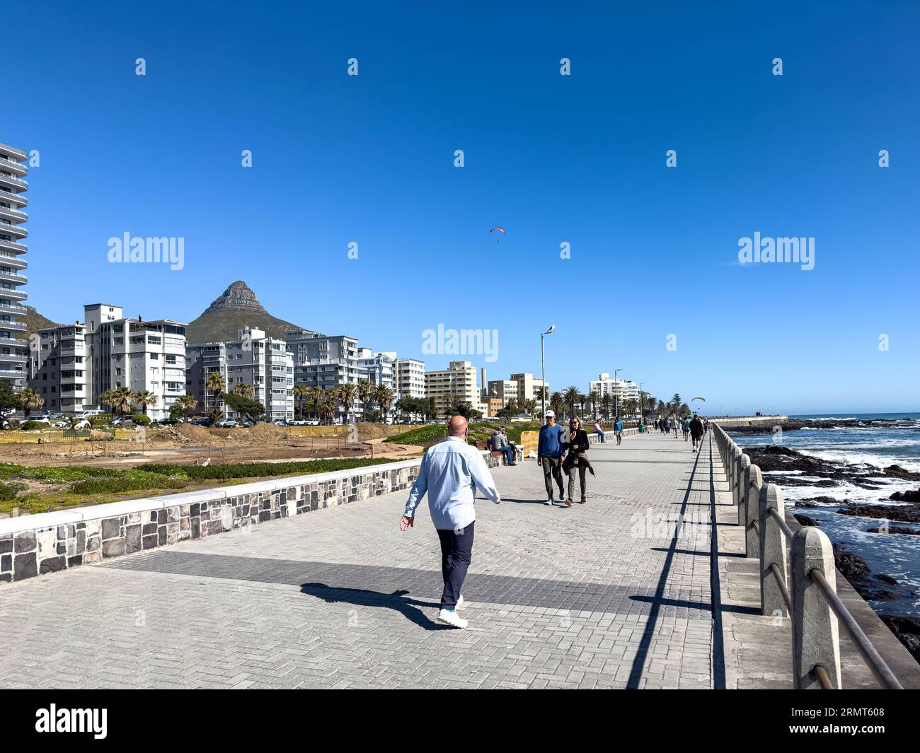 A walk along the Sea Point Promenade in Cape Town with Lions Head in ...