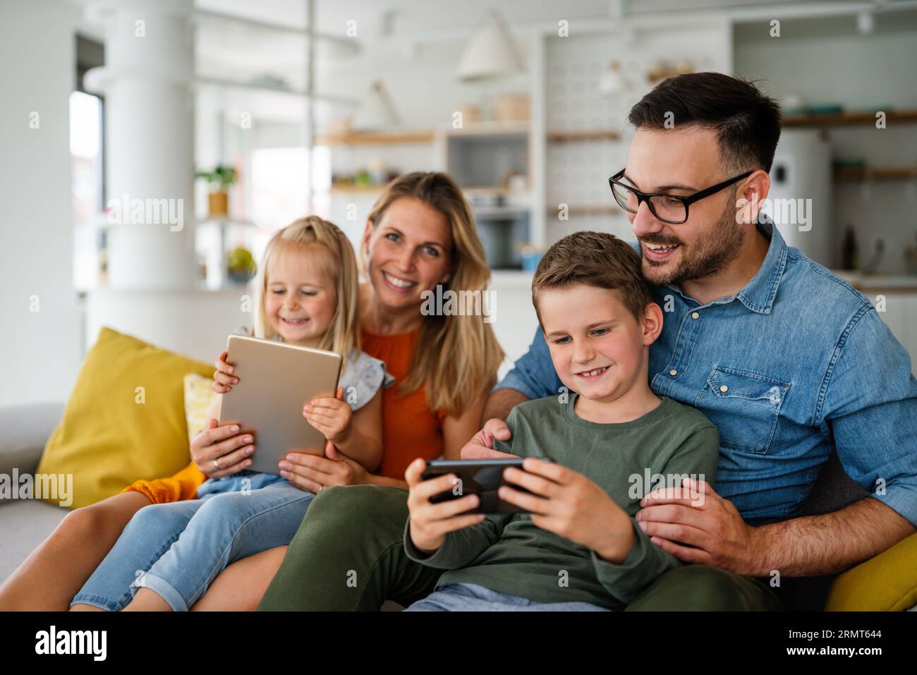 Device technology family online education concept. Happy family with ...