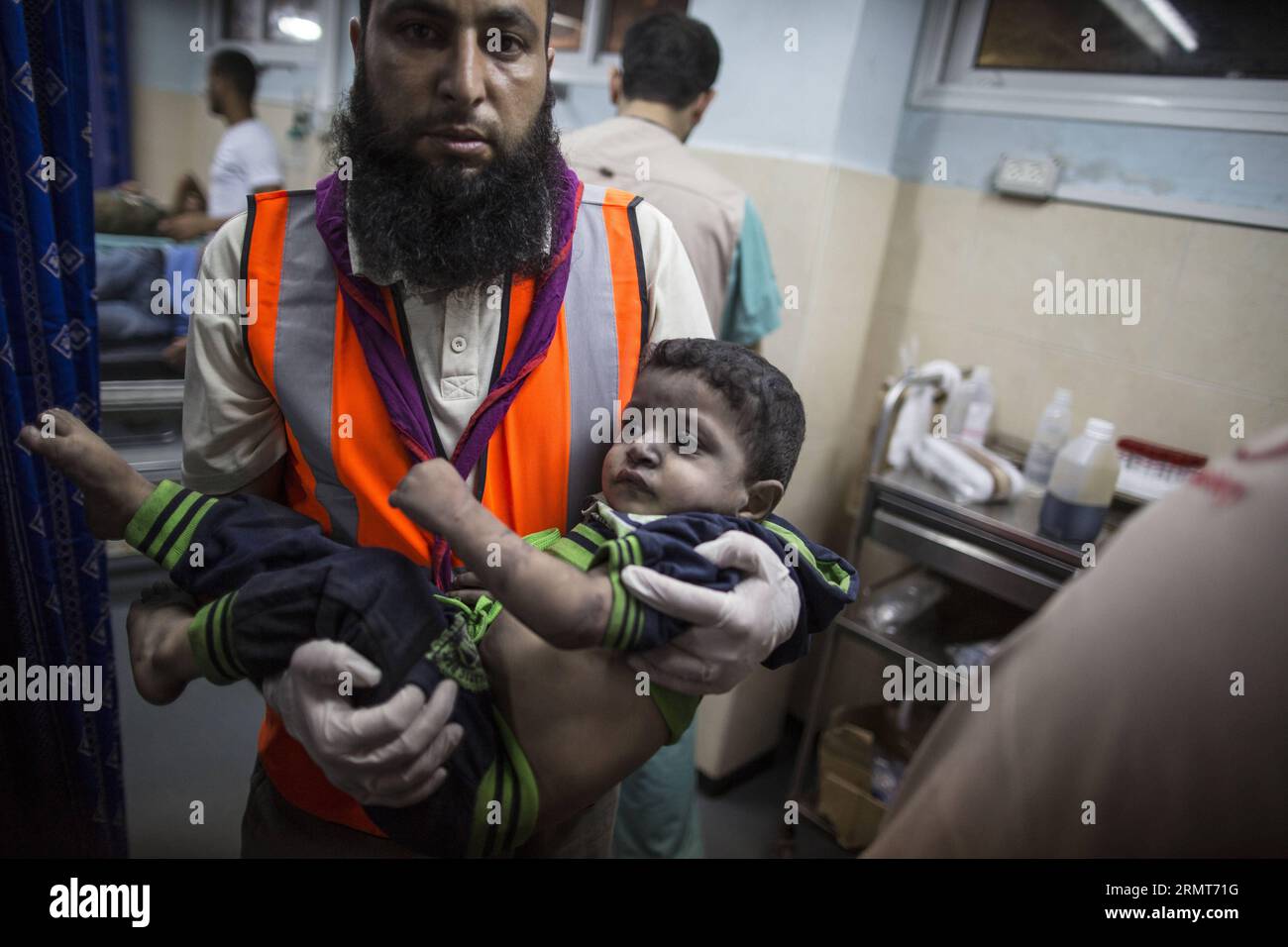 (140819) -- GAZA STRIP, August 19, 2014 -- A Palestinian medic carries ...