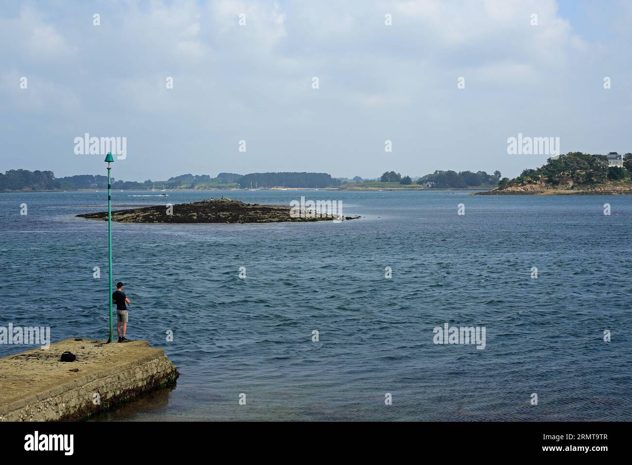 Man fishing from jetty on Pointe du Logeo, Le Logeo, Sarzeau, Morbihan ...