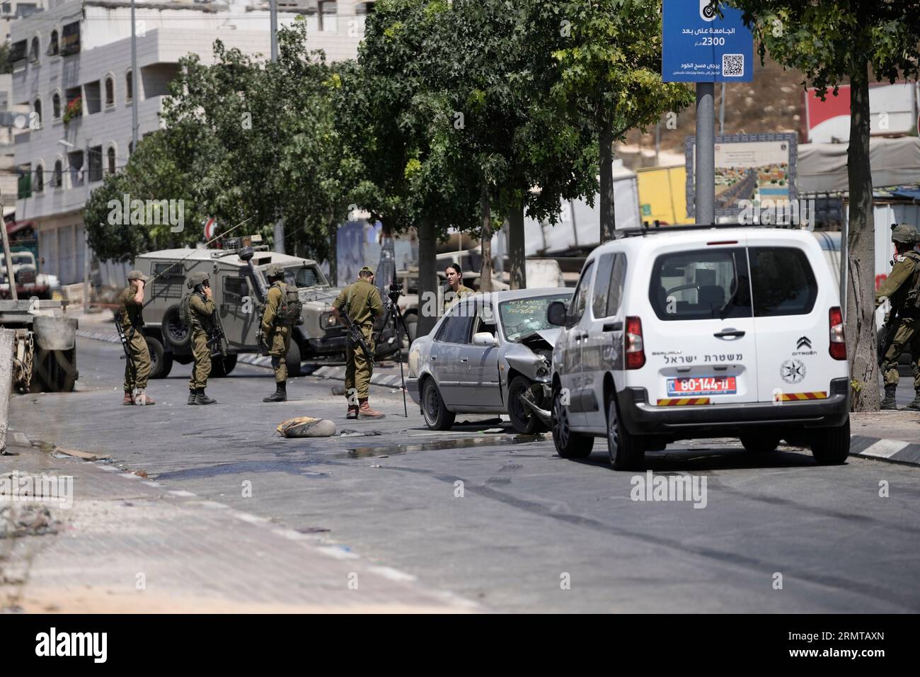 Israeli soldiers work at the site of an alleged car-ramming attack near ...