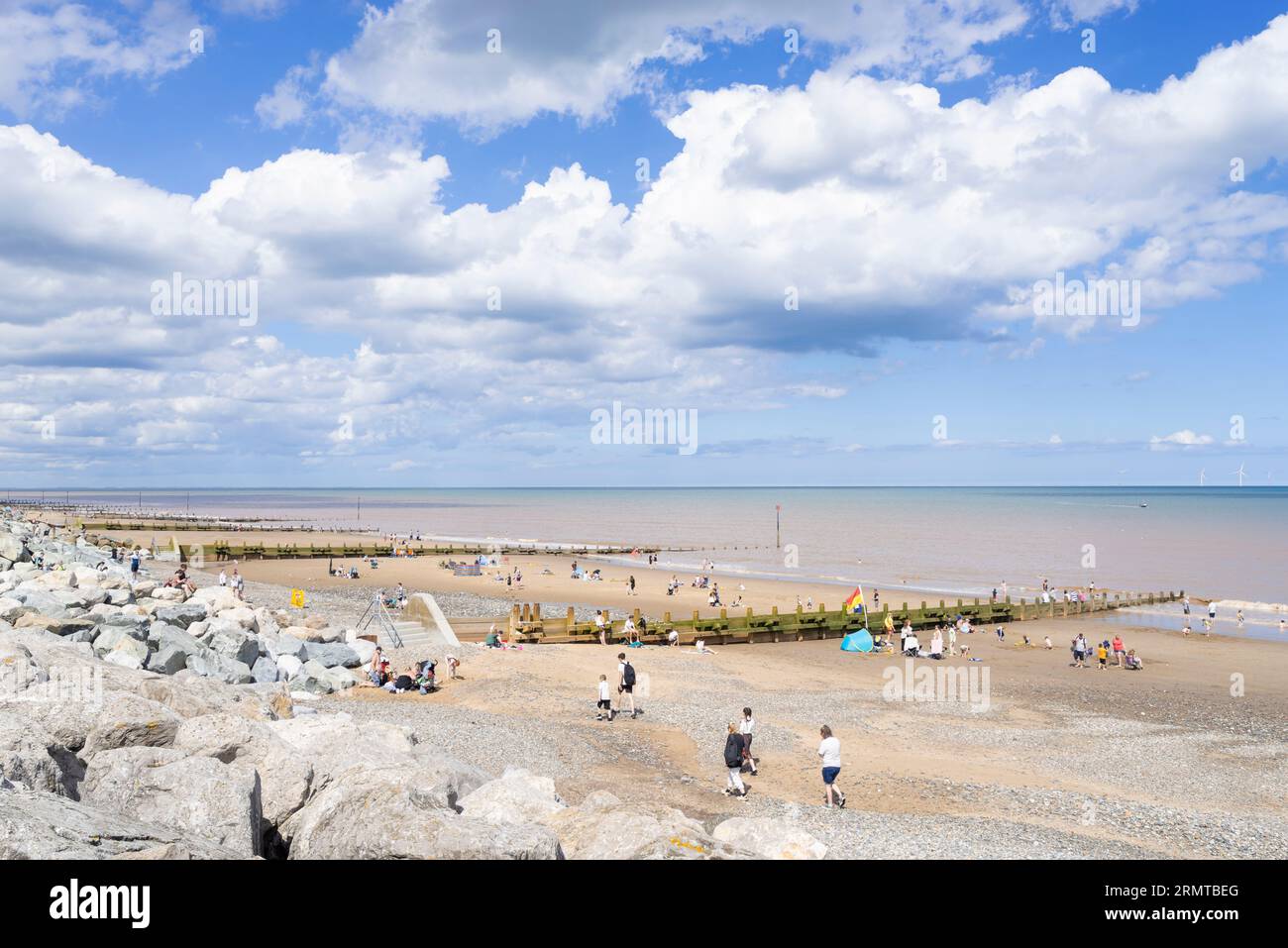 Withernsea Beach a large sandy beach with holidaymakers enjoying summer ...