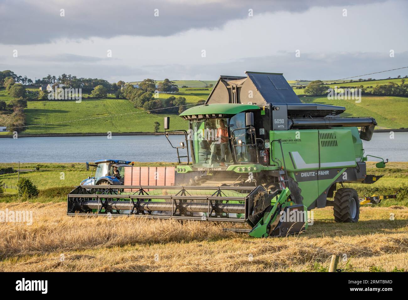 Christy Draper harvesting spring barley foe cattle feed overlooking ...