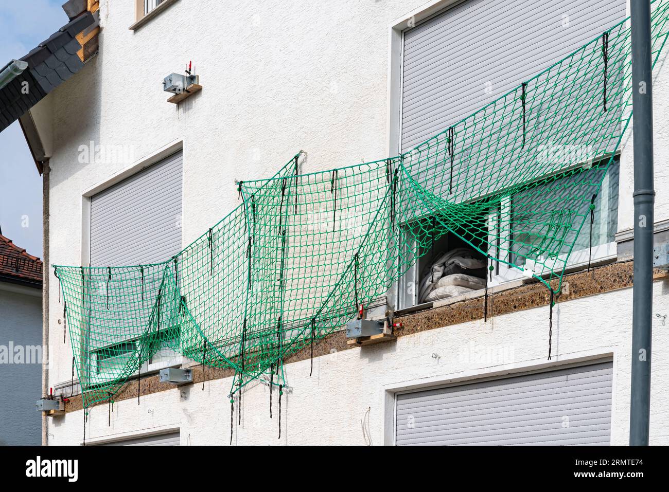 Protective green mesh on the windows of a building under construction ...