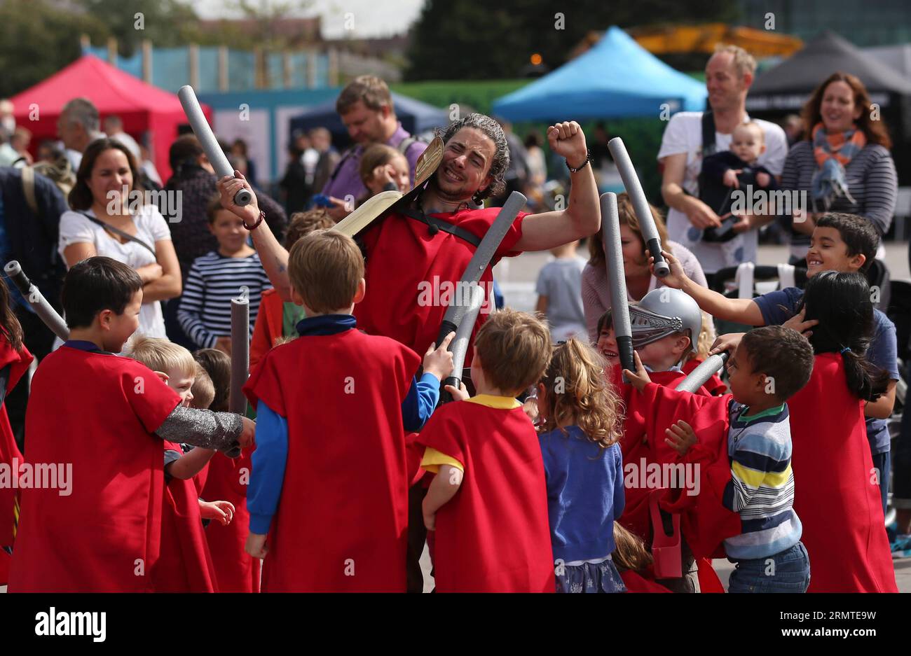 An actor plays with children during Boudicca vs the Romans at Battle ...