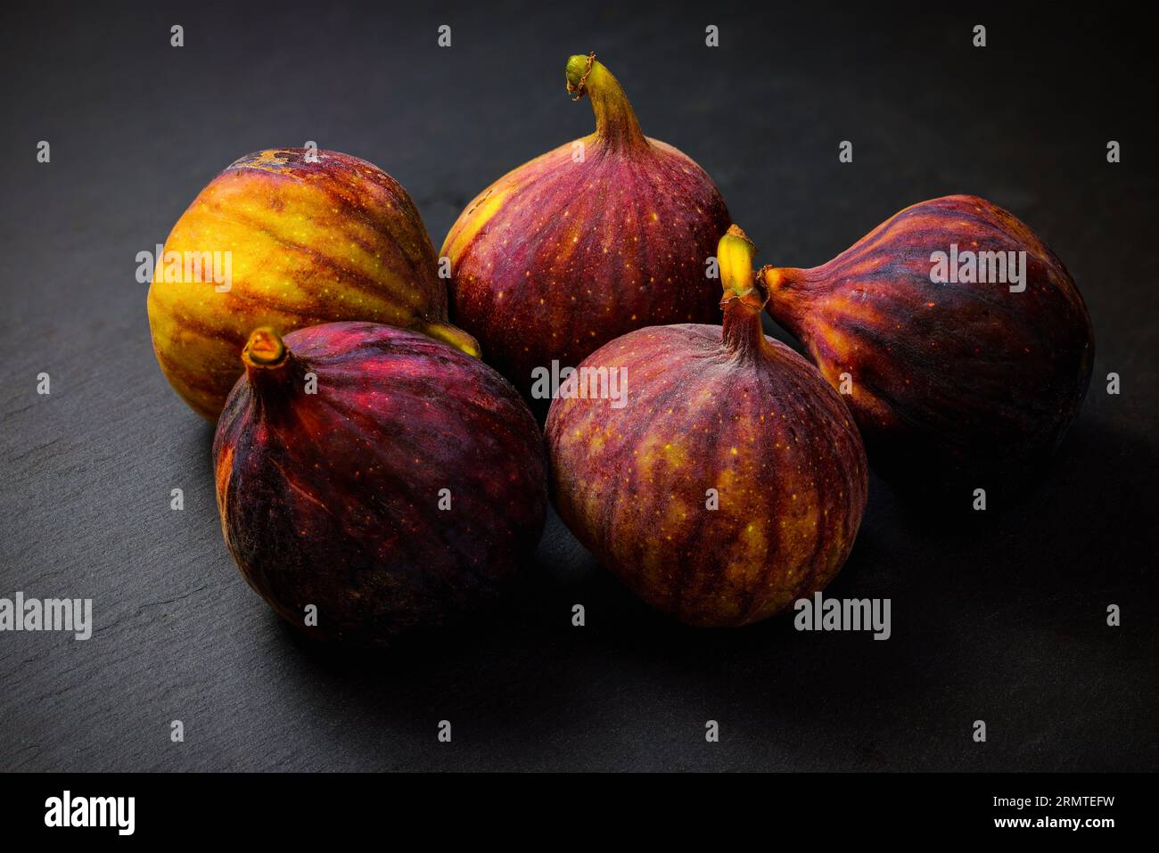figs on a stone plate isolated Stock Photo - Alamy