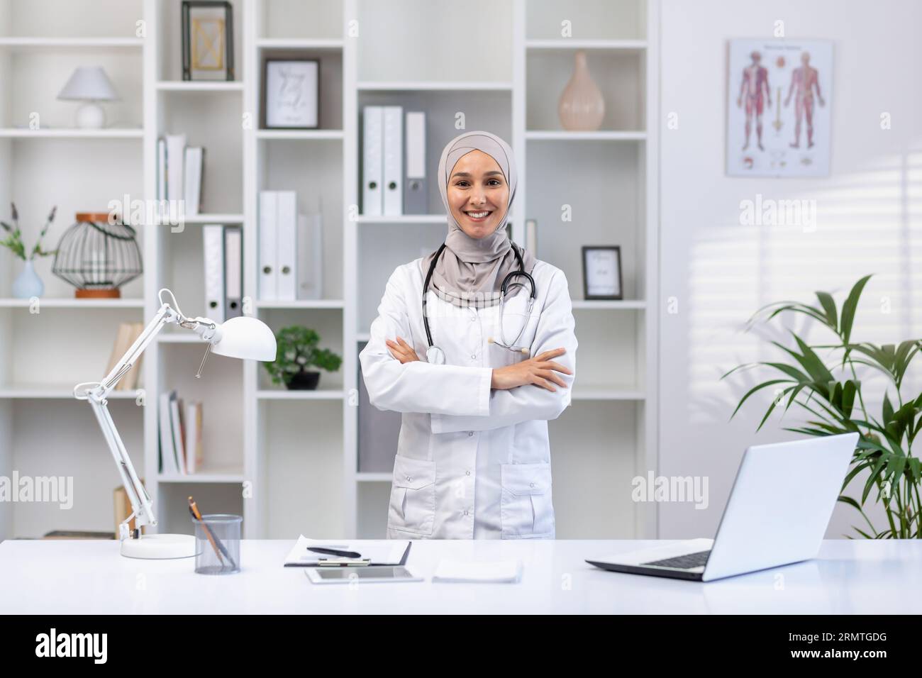 Portrait of young female doctor wearing hijab, Muslim woman smiling and ...