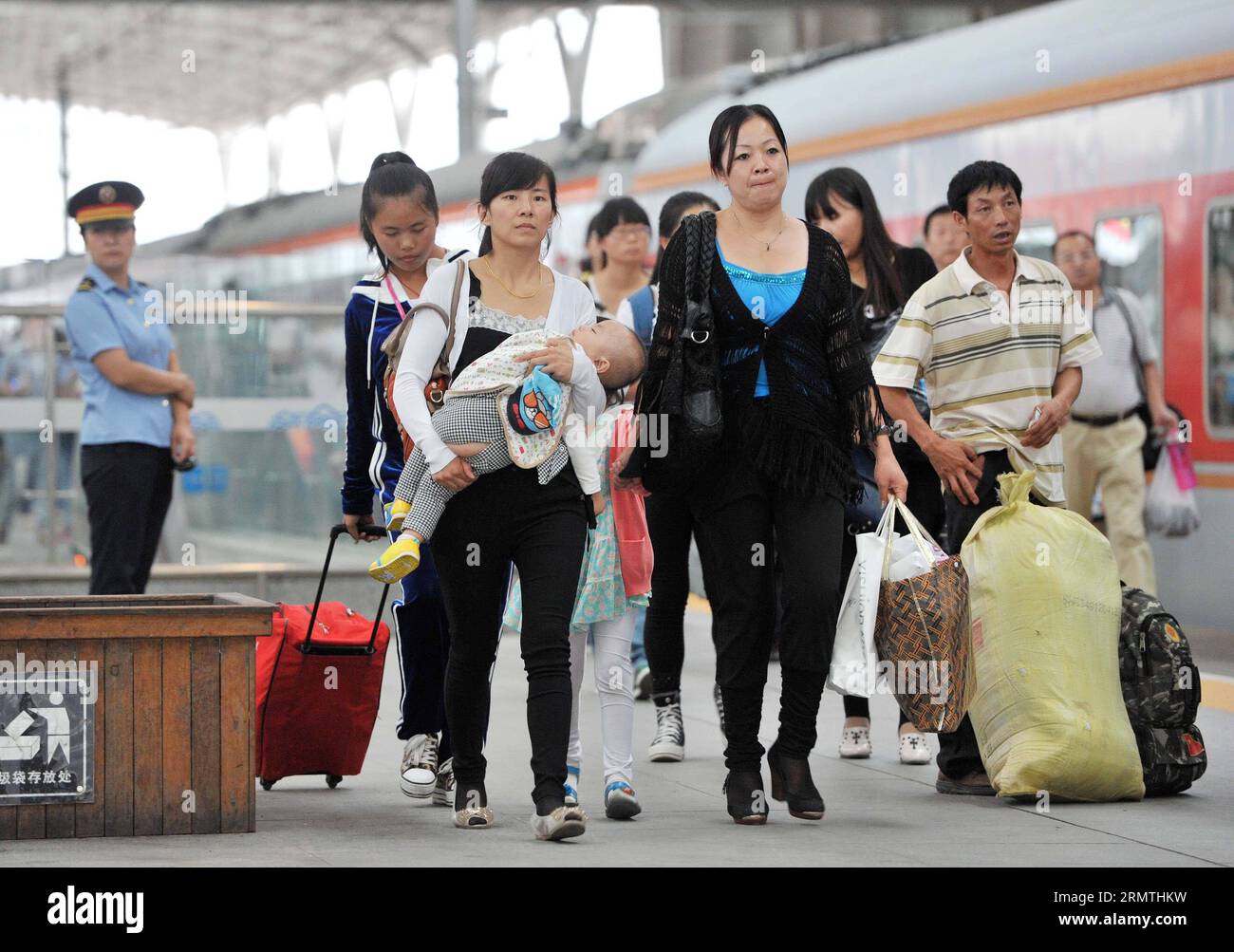 Passengers walk towards their train at the railway station of Yinchuan ...