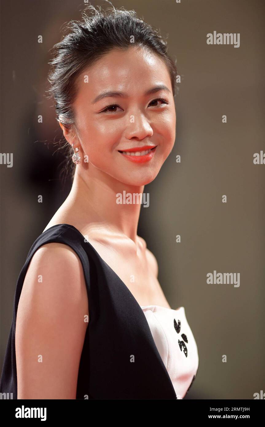 Actress Tang Wei poses on the red carpet for the awards ceremony at the ...