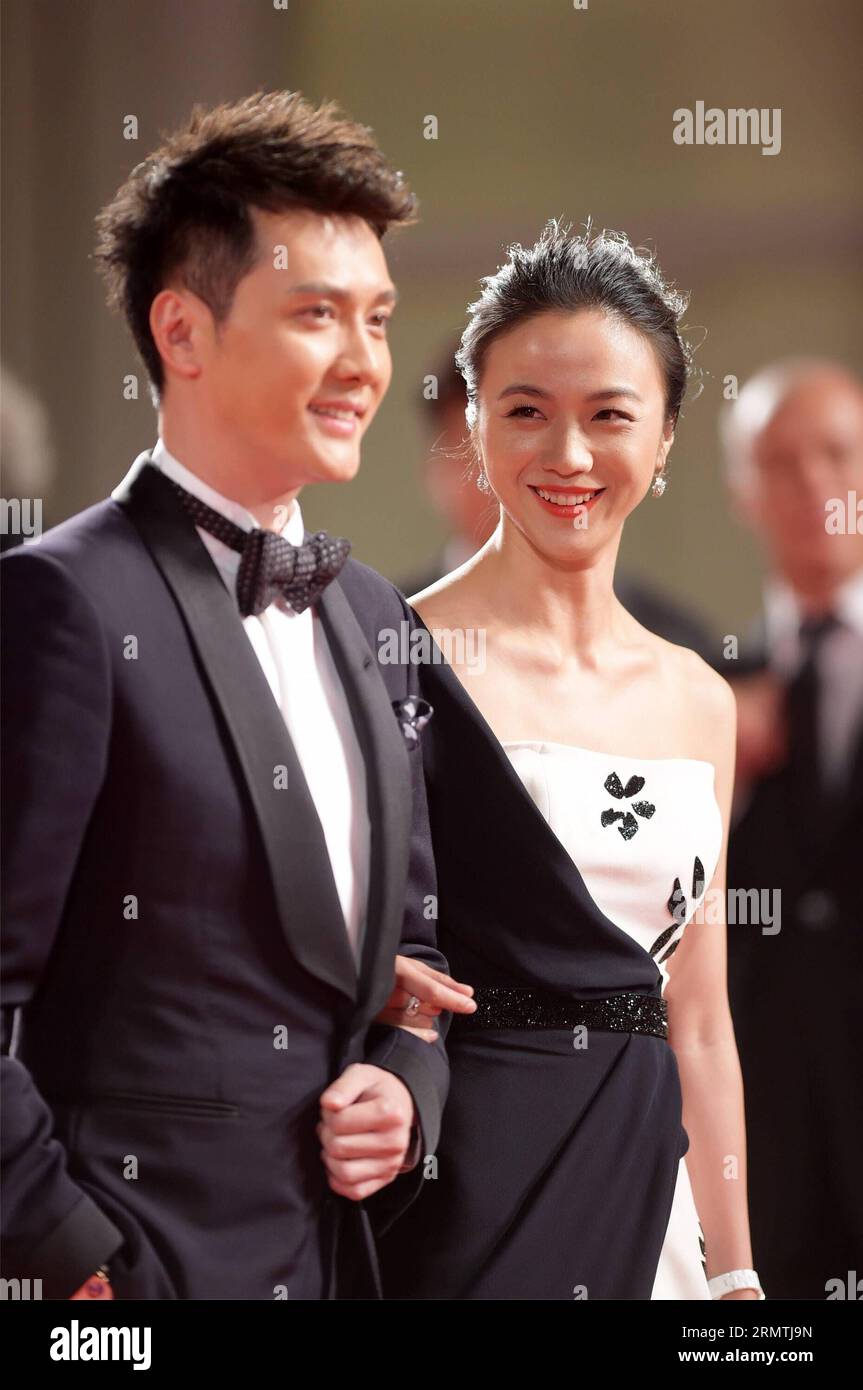 Actress Tang Wei (R) and actor Feng Shaofeng pose on the red carpet for ...