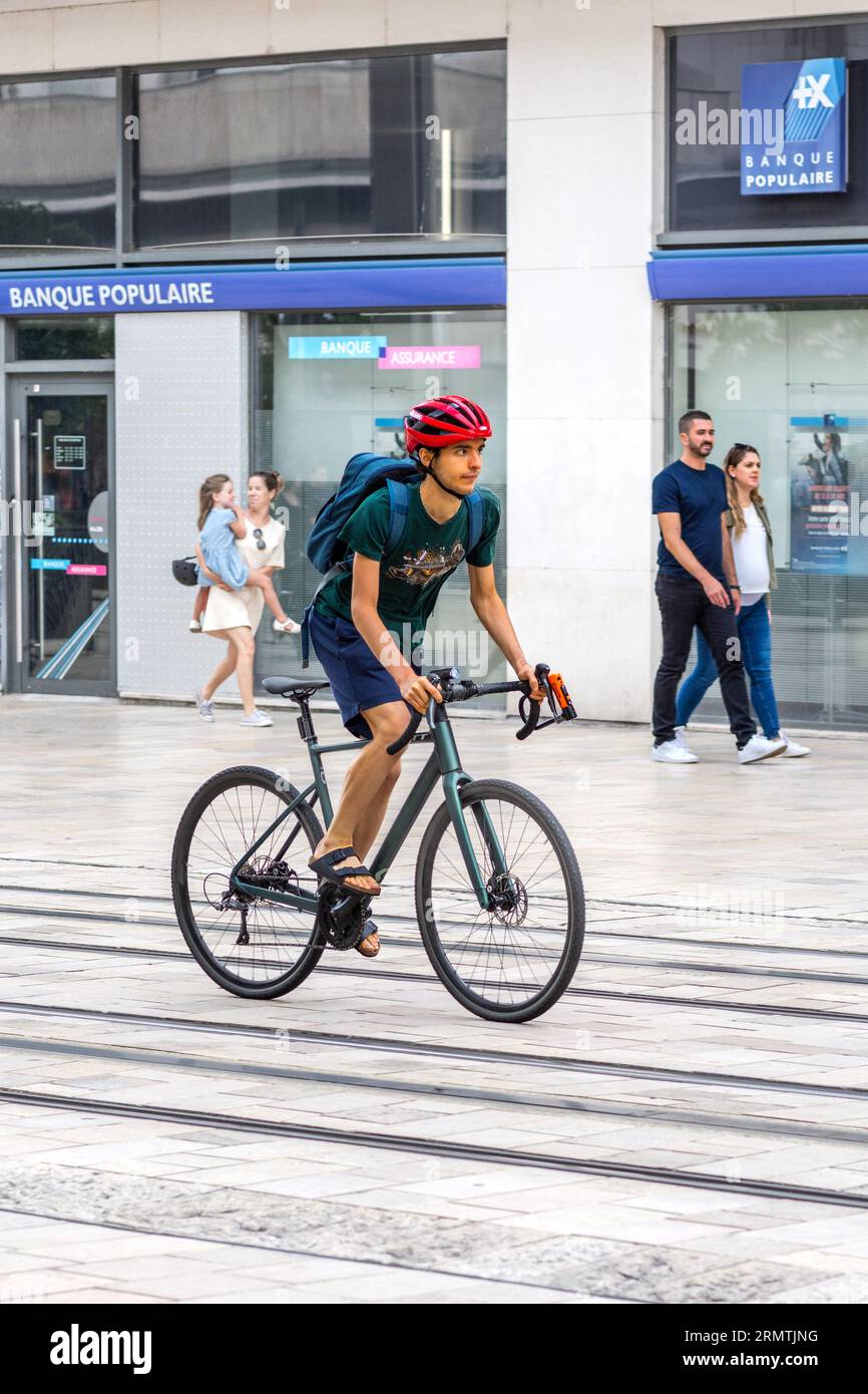 Sporty young man cycling between tram tracks - Tours, Indre-et-Loire ...