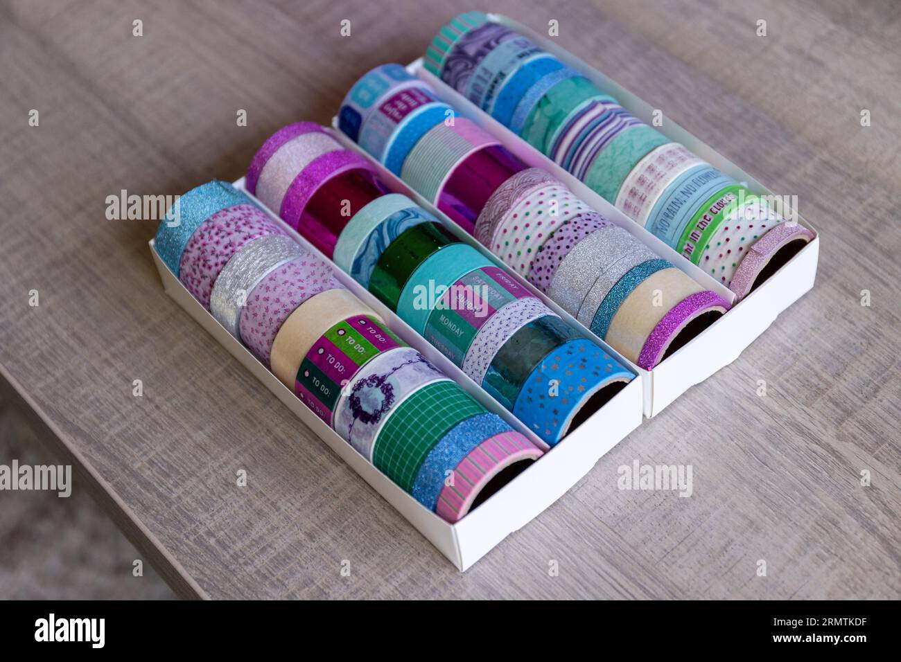 A portrait of a box full of colorful rolls of washi tape having ...