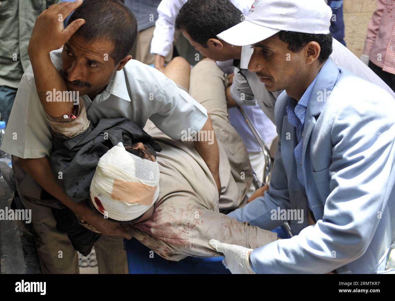 SANAA, Sept. 9, 2014 -- People carry a protester who was injured in ...