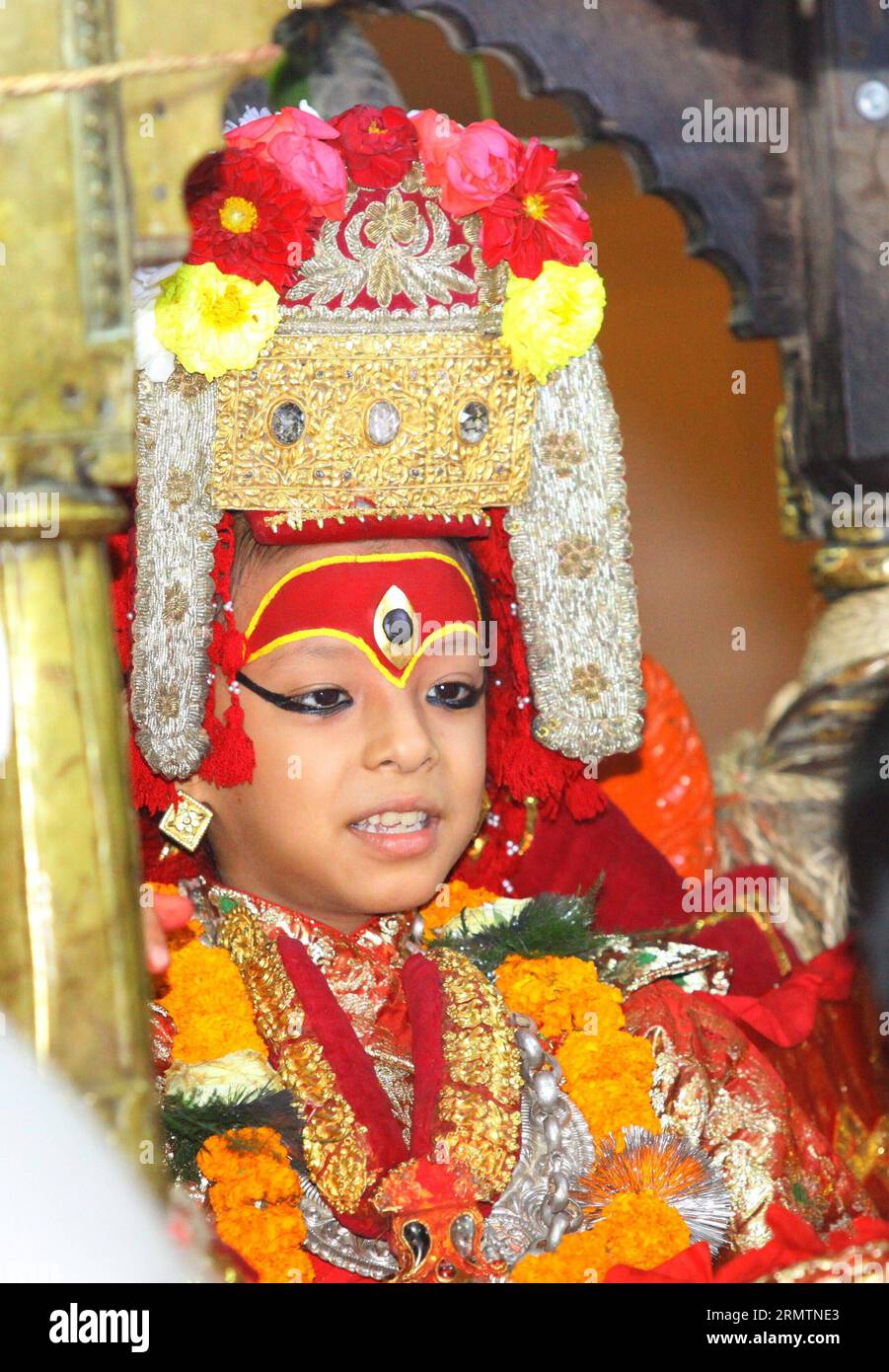 A boy performing as Lord Ganesh smiles during the chariot procession on ...