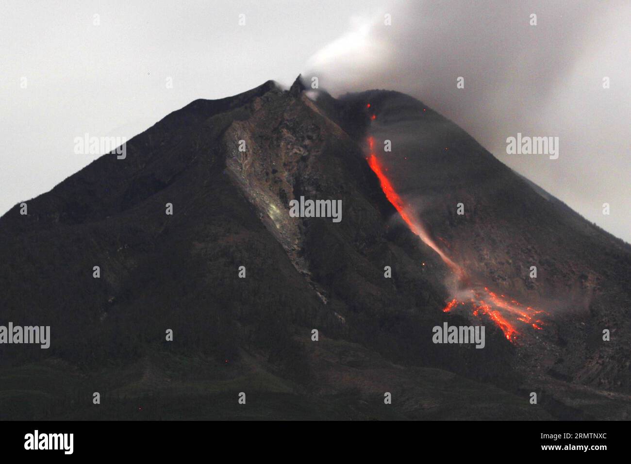 The slow shutter speed photo taken on Sept. 12, 2014 shows lava flowing ...