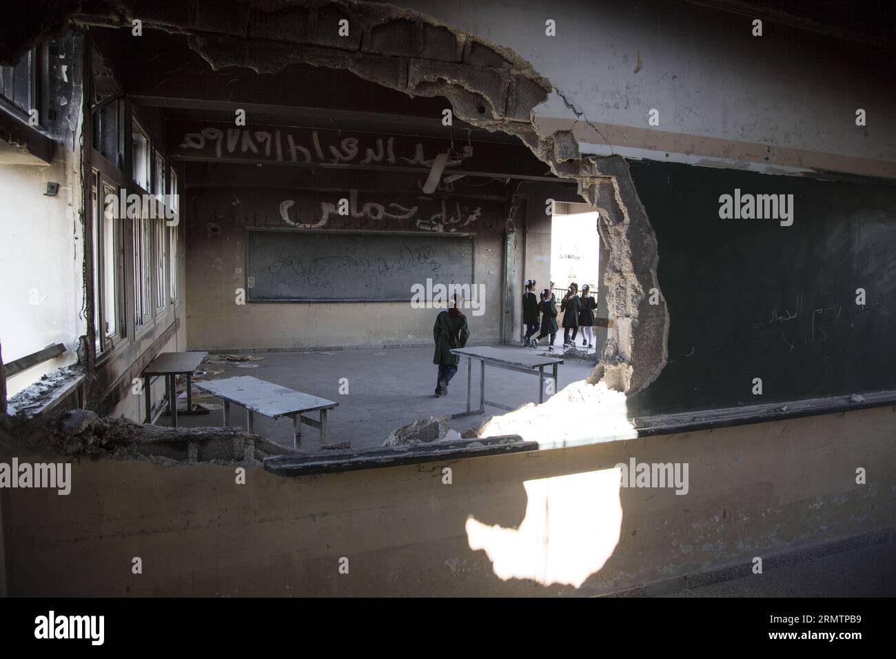 Palestinian students are seen inside their damaged classroom on the ...