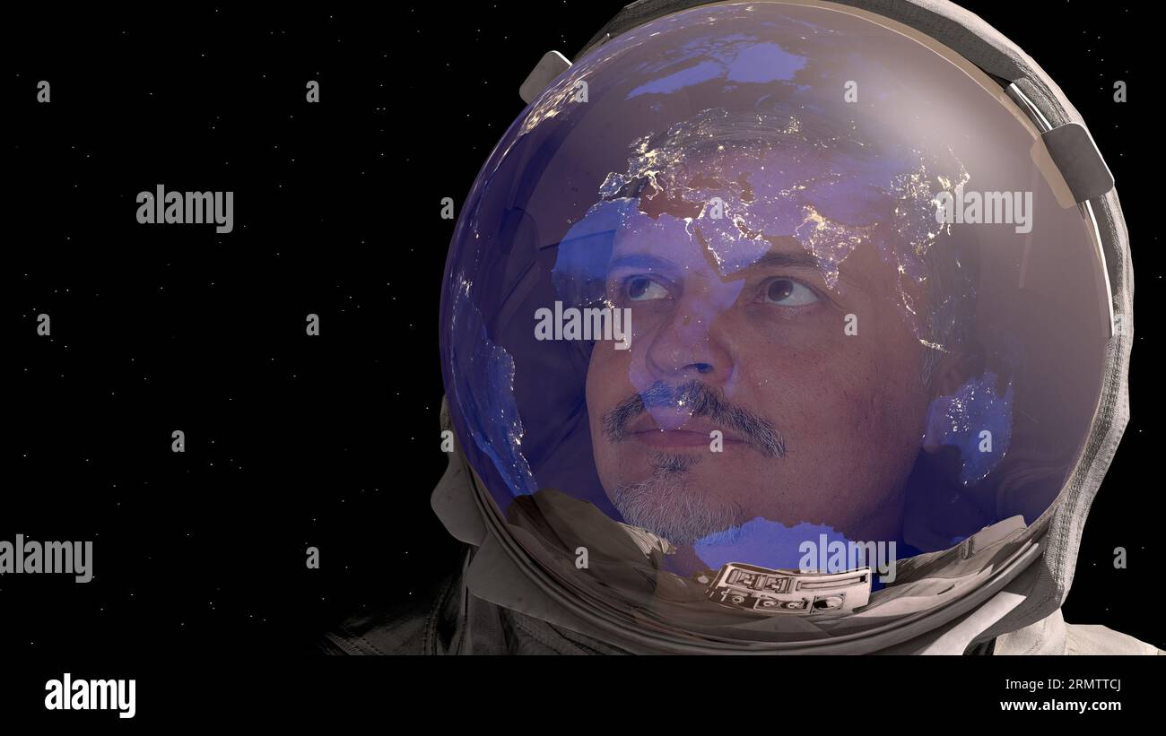 Portrait of man astronaut in outer space wearing helmet looking at ...