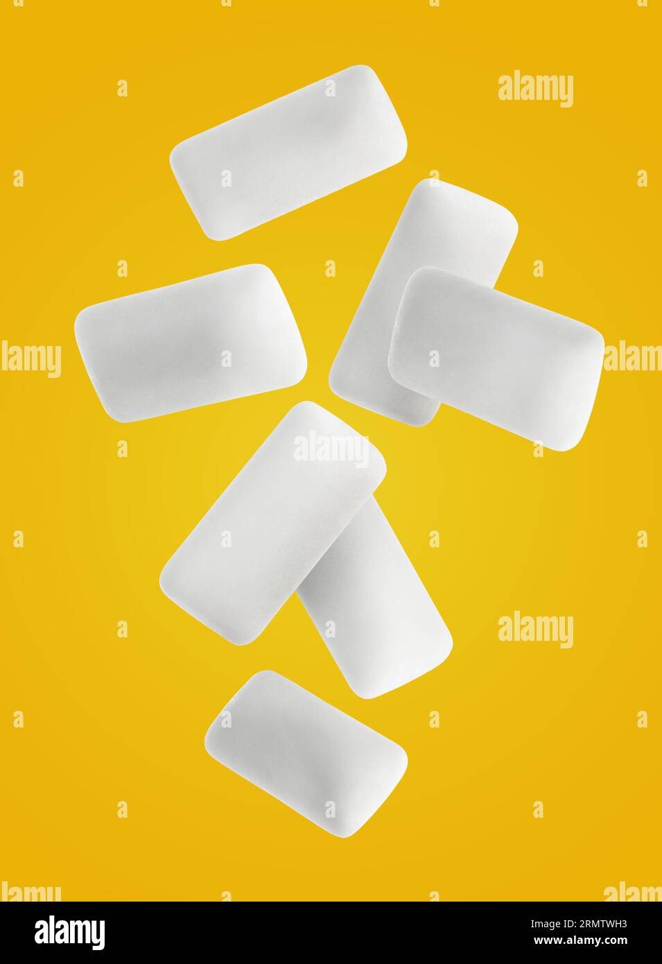 Many chewing gum pads falling on golden background Stock Photo - Alamy