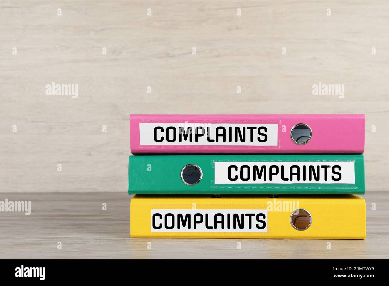 Colorful folders with Complaints labels on table, space for text Stock ...