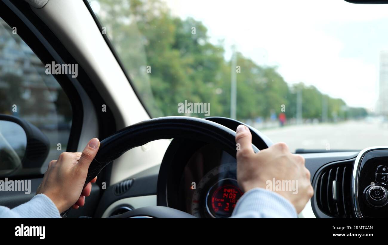 Close up. Inside car footage. Female hands on steering wheel driving ...