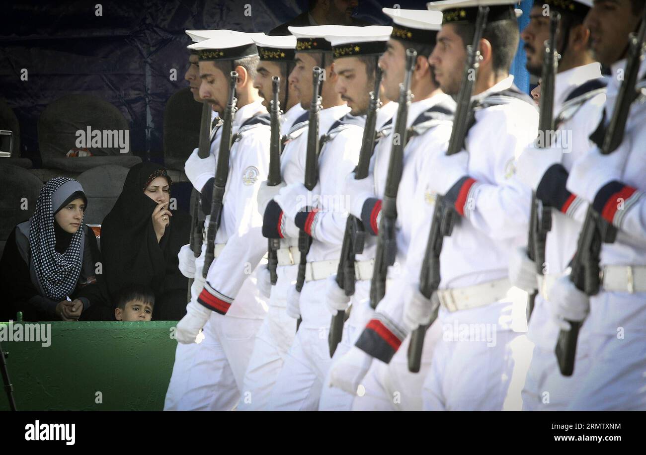 (140922) -- TEHRAN, Sept. 22, 2014 -- People watch a military parade ...