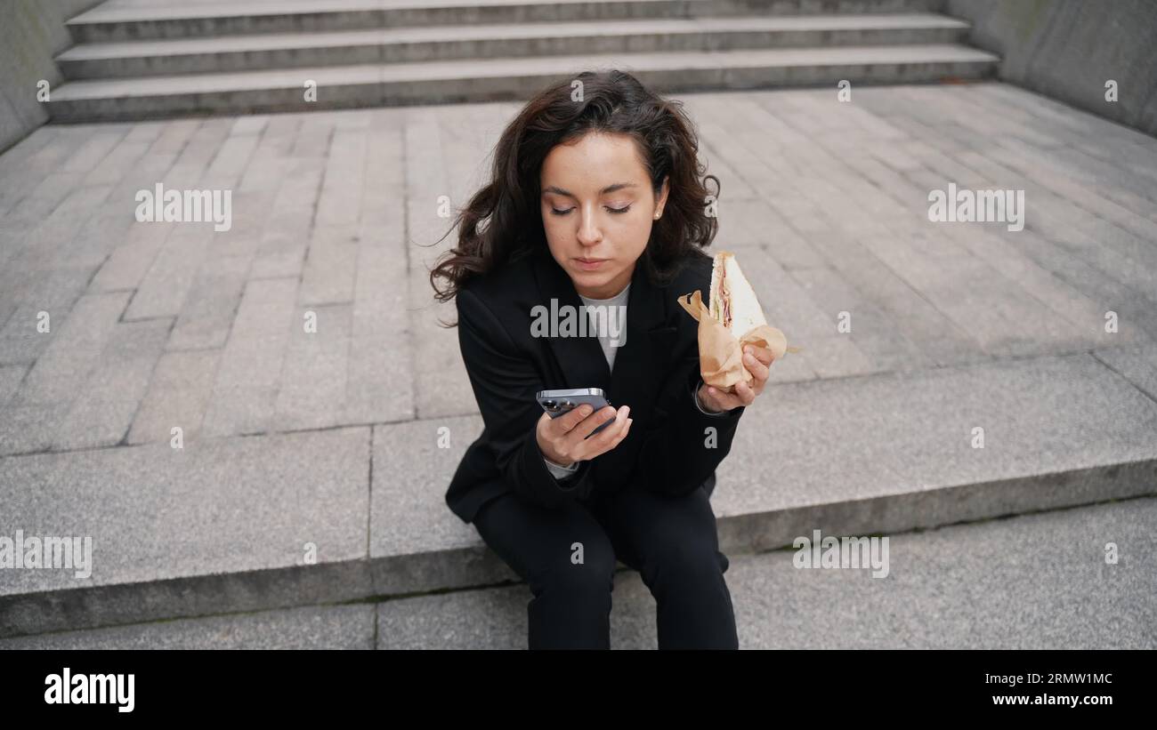 Caucasian girl with brown long hair sitting on stairs in downtown ...