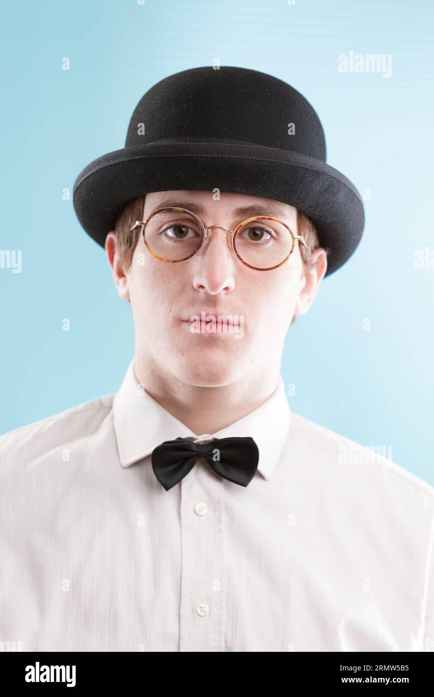 Set against a business blue canvas, a young man exemplifies the nerd ...