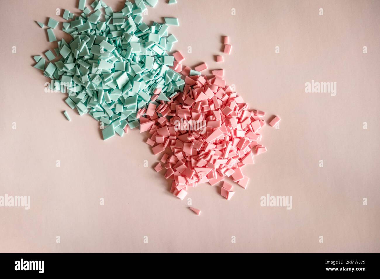 A pile of plastics - small pieces of hard plastic, pink and blue color ...