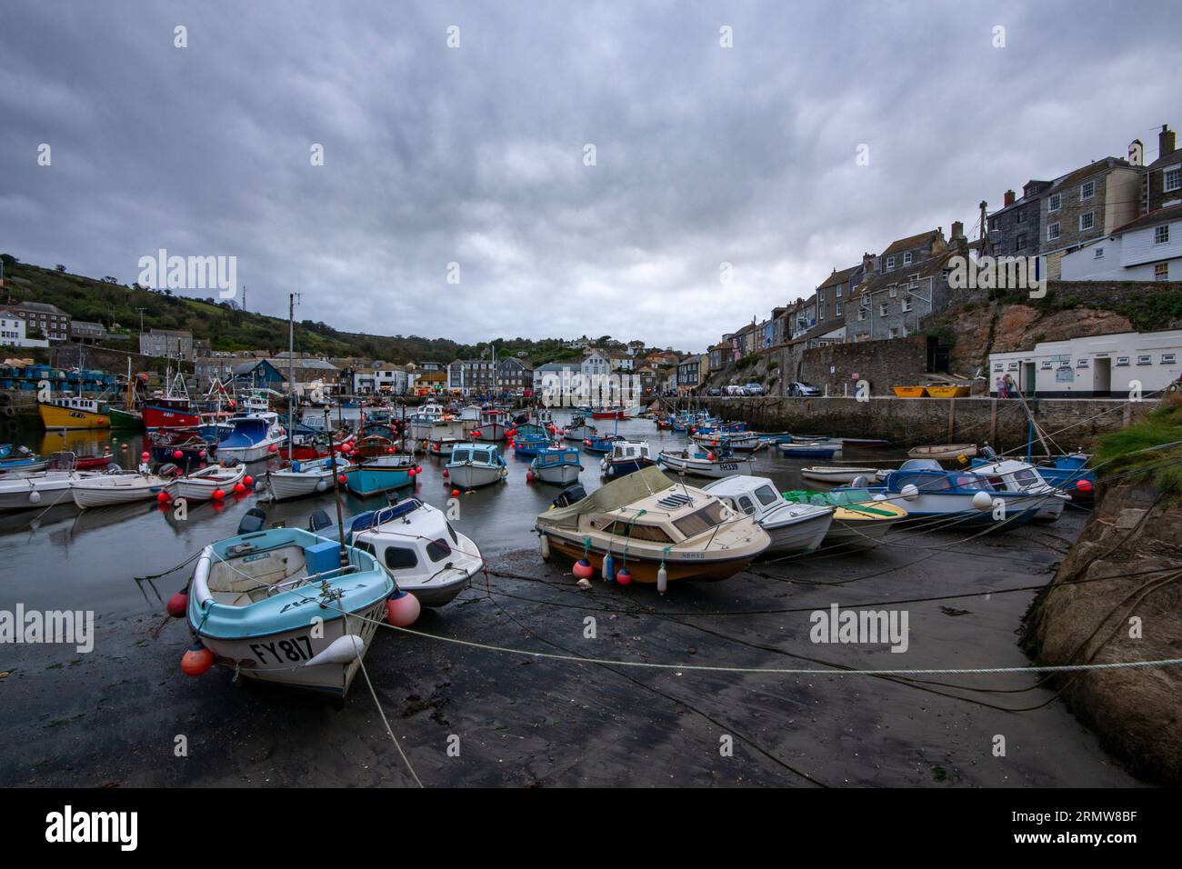 Dramatic stormy harbour scene in the quaint traditional Cornish fishing ...