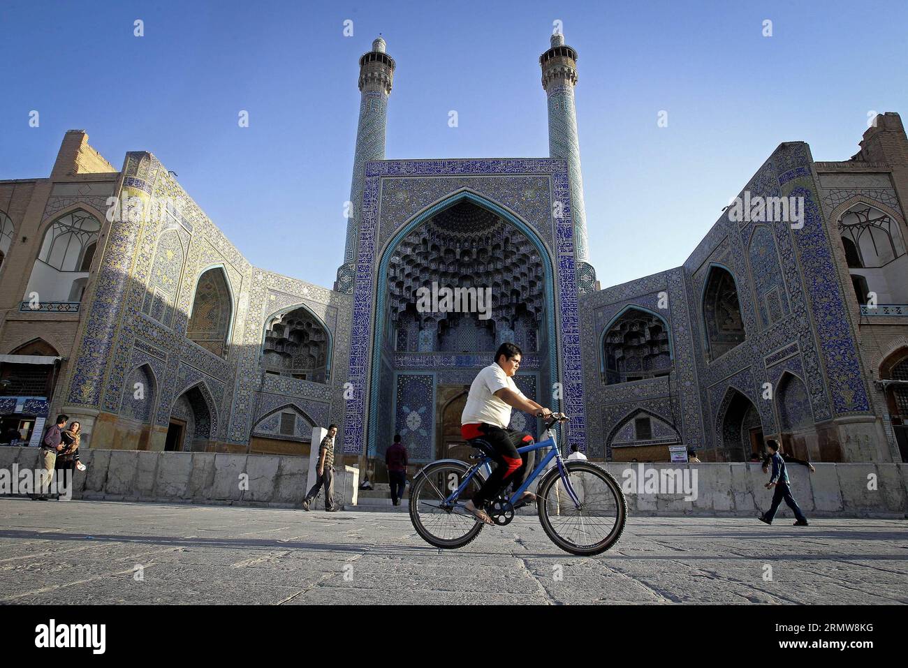 A boy rides a bicycle at the Naghshe Jahan Square in Isfahan, 234 miles south of Tehran, Iran ...
