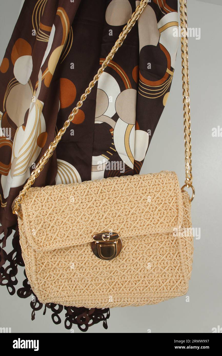 Crocheted light beige color bag with brown shawl isolated on white ...