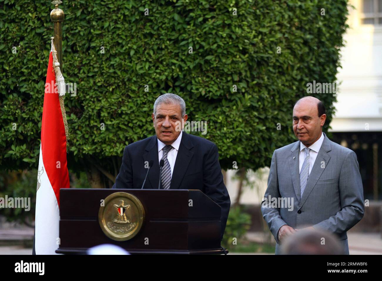 Egyptian Prime Minister Ibrahim Mahlab (L) and head of the Suez Canal ...